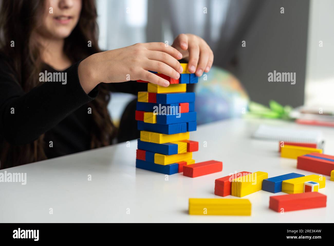 Children building wood blocks at playground. Girl kid playing stacking ...