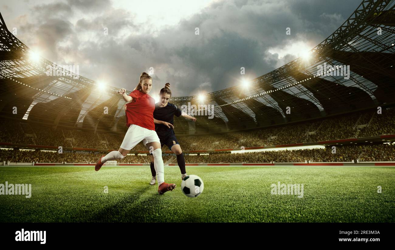 Two competitive women, football players in motion during match, game ...
