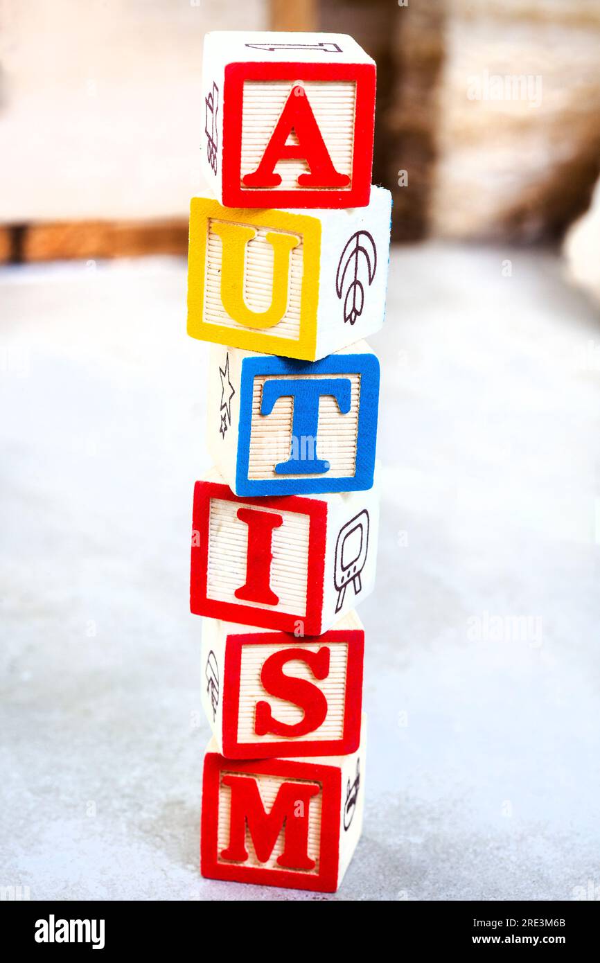 Autism spelled out in kids building blocks on mottled grey Stock Photo ...
