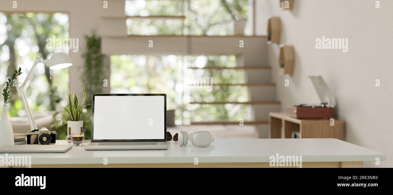 A modern home office workspace with a laptop white screen mockup ...