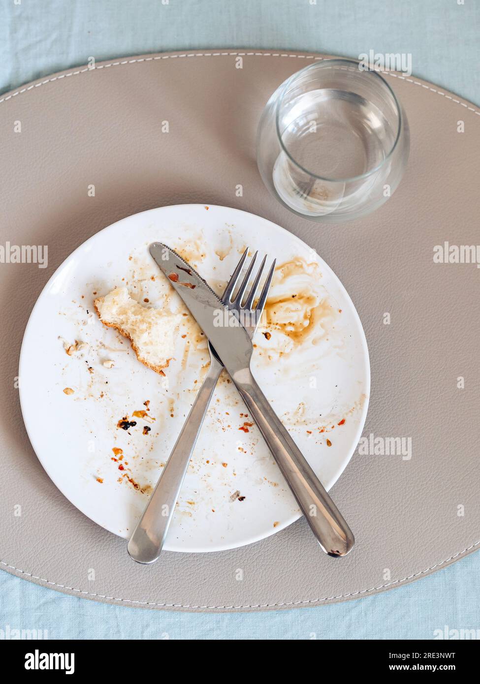 dirty plate after eating on the dining table. Top view of dirty white ...