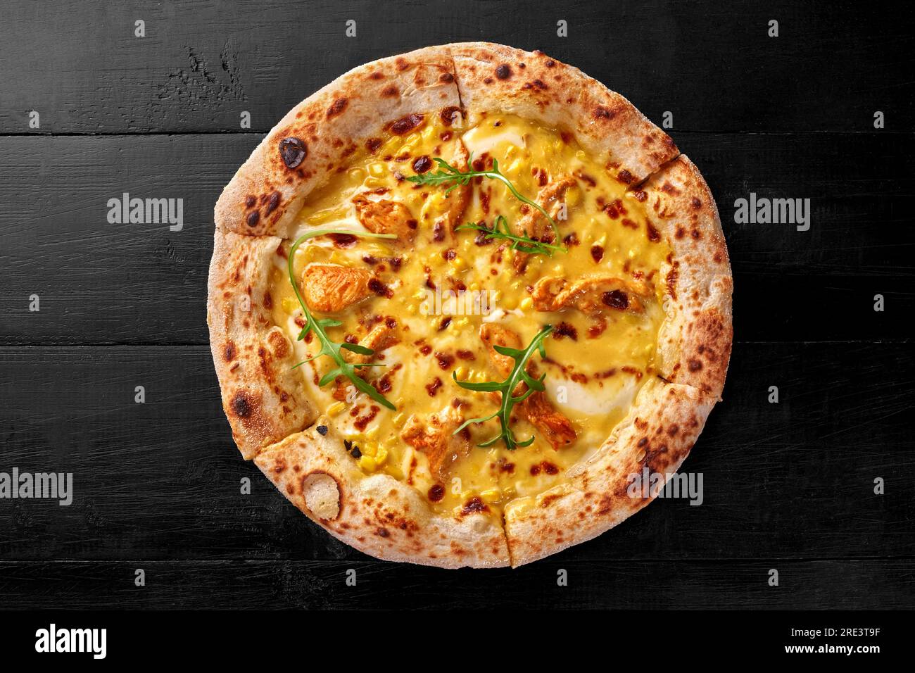 Pizza with melted cheese, sous vide chicken, corn and arugula Stock ...