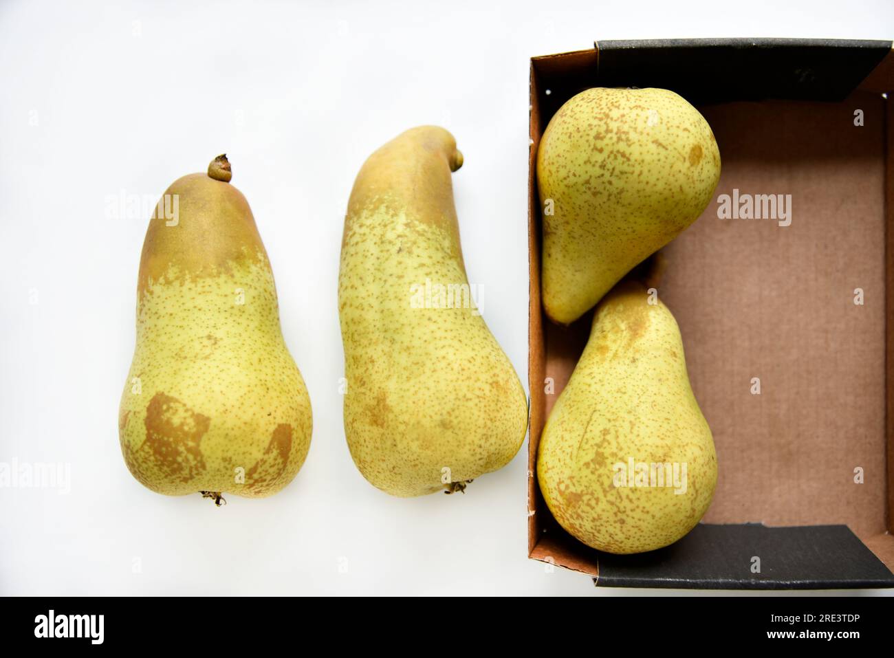 Green pears in a cardboard box on a white background. Summer sale Stock ...