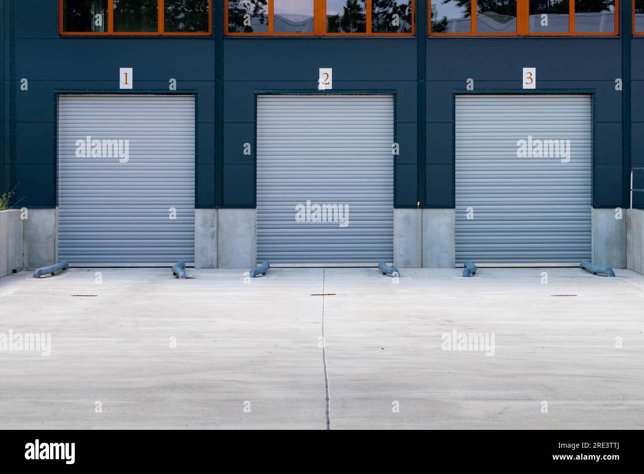 Three roller garage doors next to each other. Numbers on the doors ...