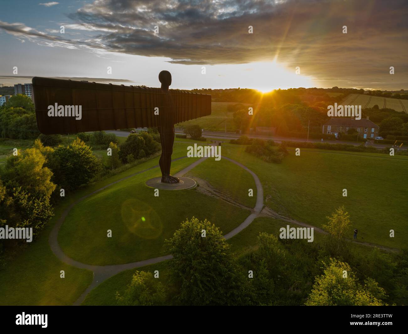 Dramatic side on drone shot of Angel of the North with sun rising on ...