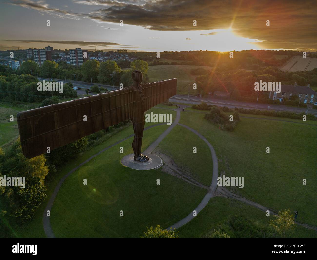 Raised side on drone shot of Angel of the North with sun rising on the ...