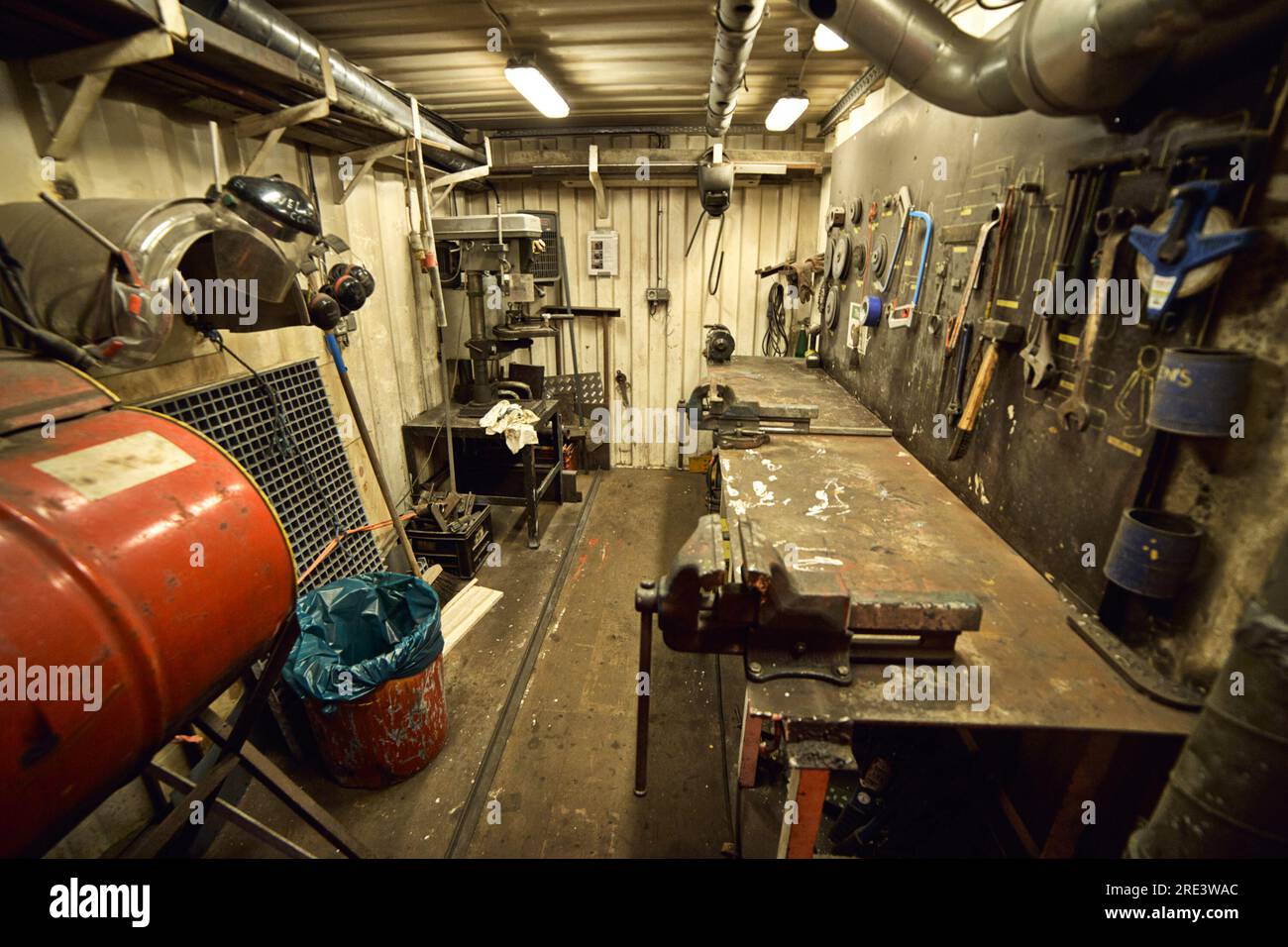 Dirty workshop with tools on the wall located on old jack up rig Stock ...