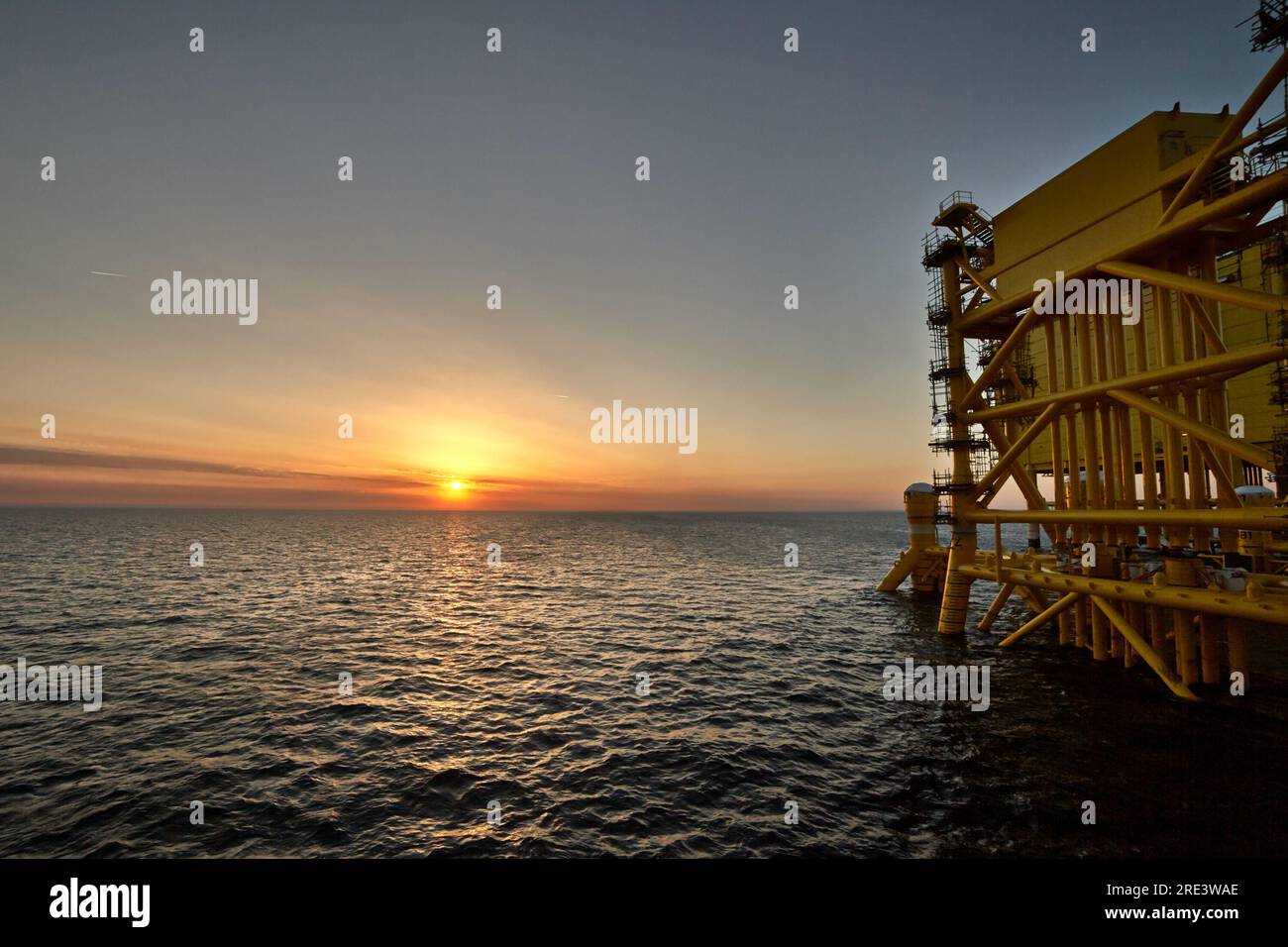 Sunset in the sea with offshore construction Stock Photo - Alamy