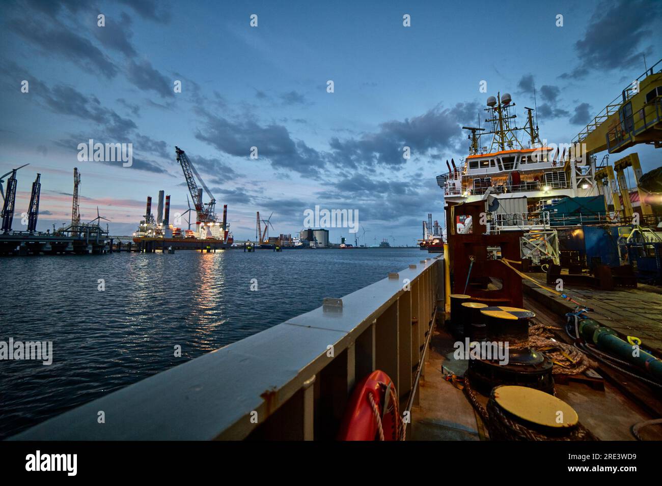 Sunset view from the vessel in the harbor with wind turbines on the ...