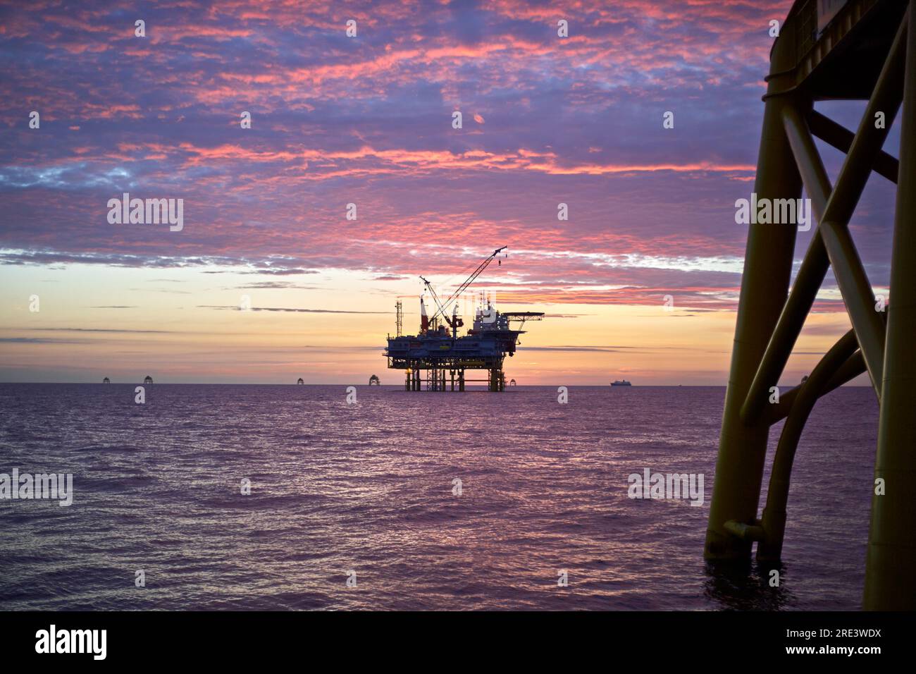 Offshore Wind farm electrical station in the sea at sunrise with part ...