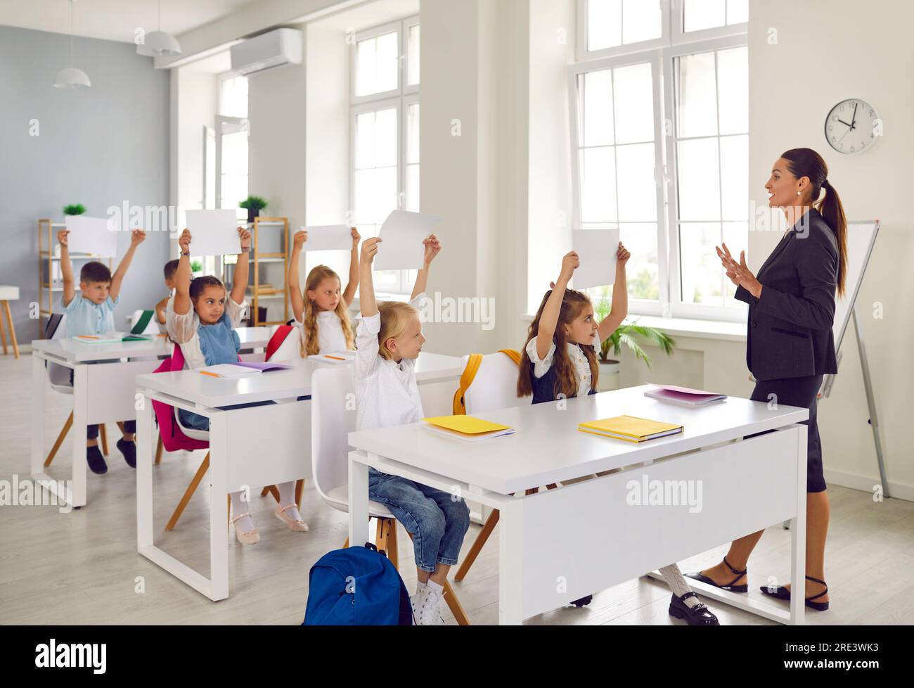 Whole class happily raised their hands knowing answer to question asked ...