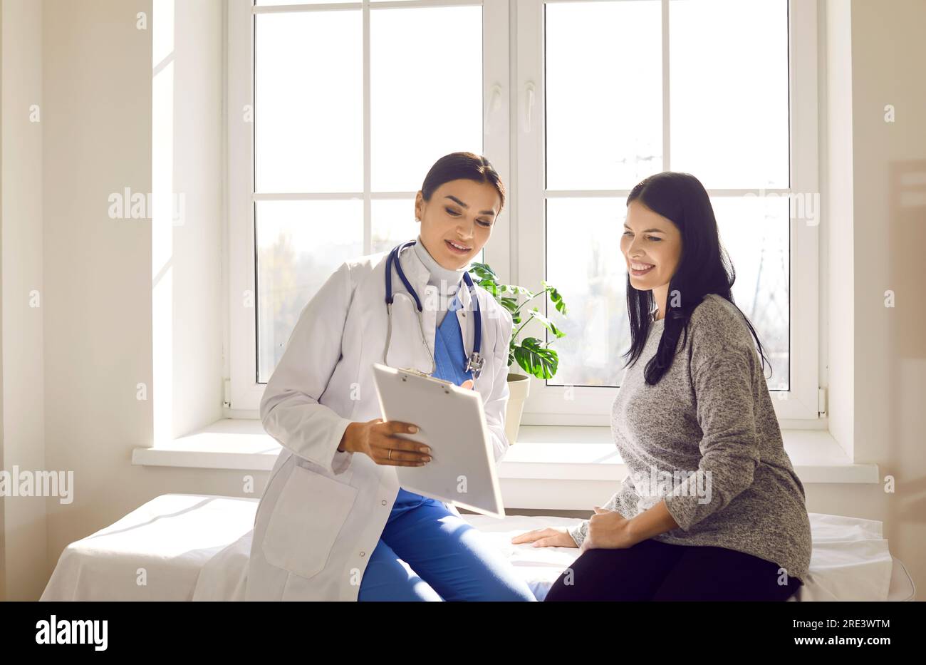 Doctor showing report file with appointment and giving consultation to ...