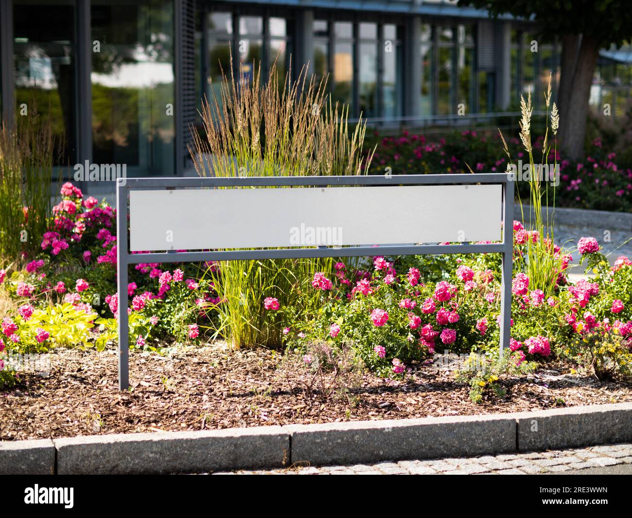 Blank signboard in front of an office building exterior. Empty template ...