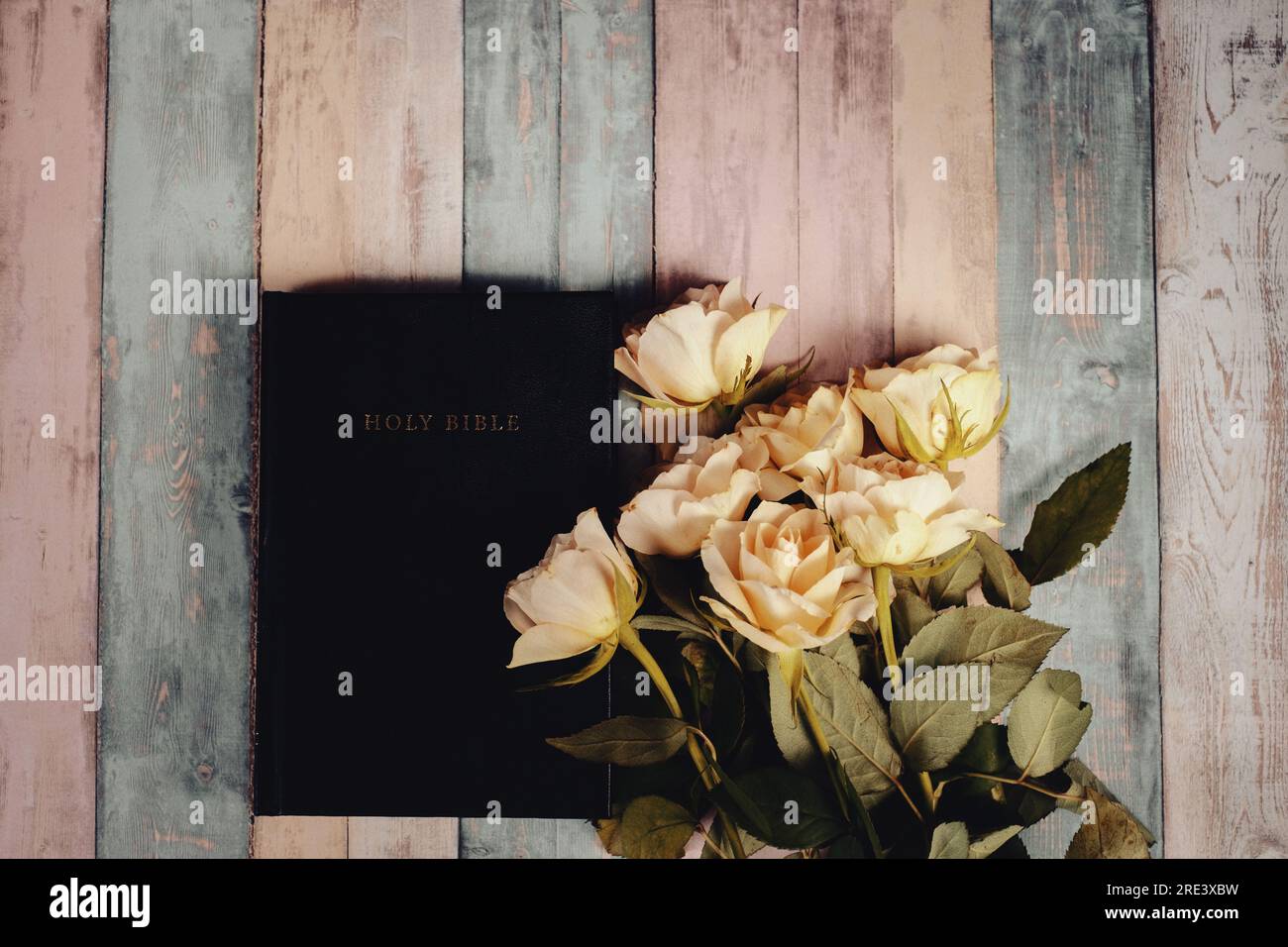 Roses and Holy Bible on the wooden background. Christian background ...