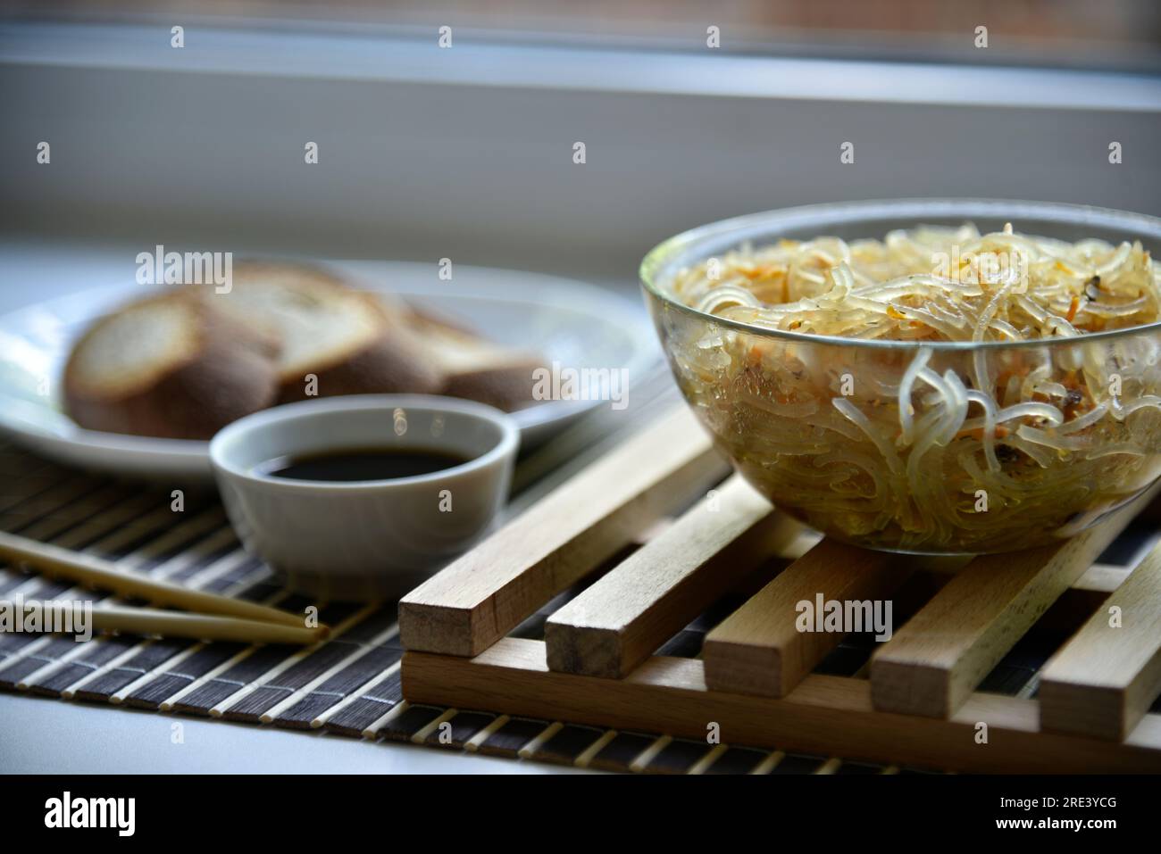 Korean rice noodles with meat and spices. Noodles with sauce and bread ...