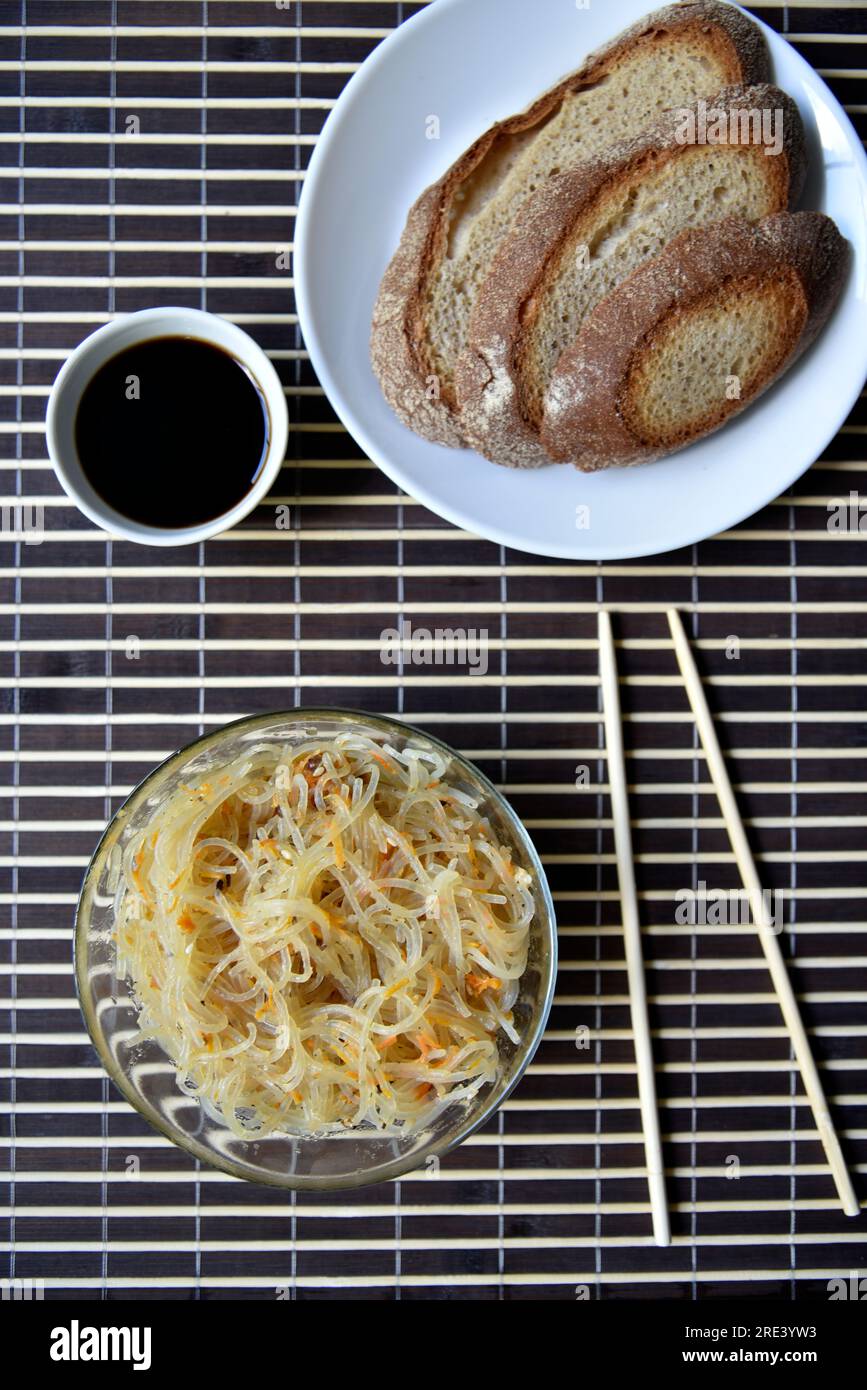 Korean rice noodles with meat and spices. Noodles with sauce and bread ...