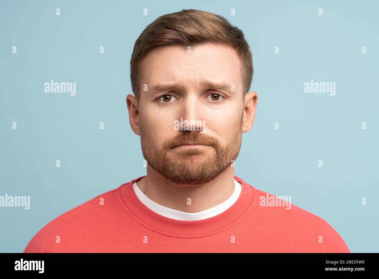 Lack of energy. Offended man with blowing lips sadly looking at camera ...