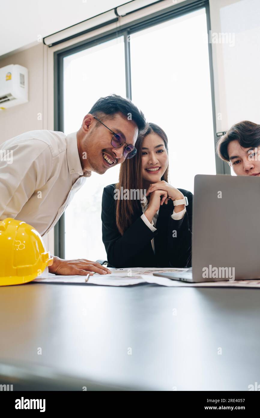 multi ethnic engineer brainstorming and measuring for cost estimating ...