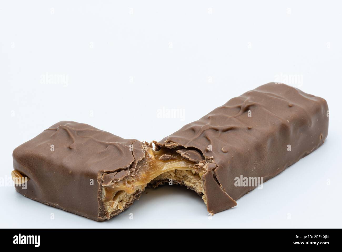 Chocolate bar with caramel inside on a white background Stock Photo - Alamy