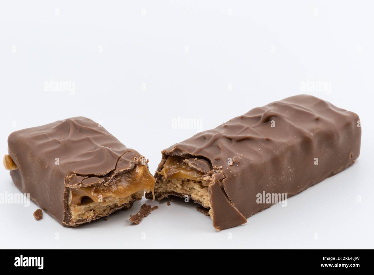 Chocolate bar with caramel inside on a white background Stock Photo - Alamy