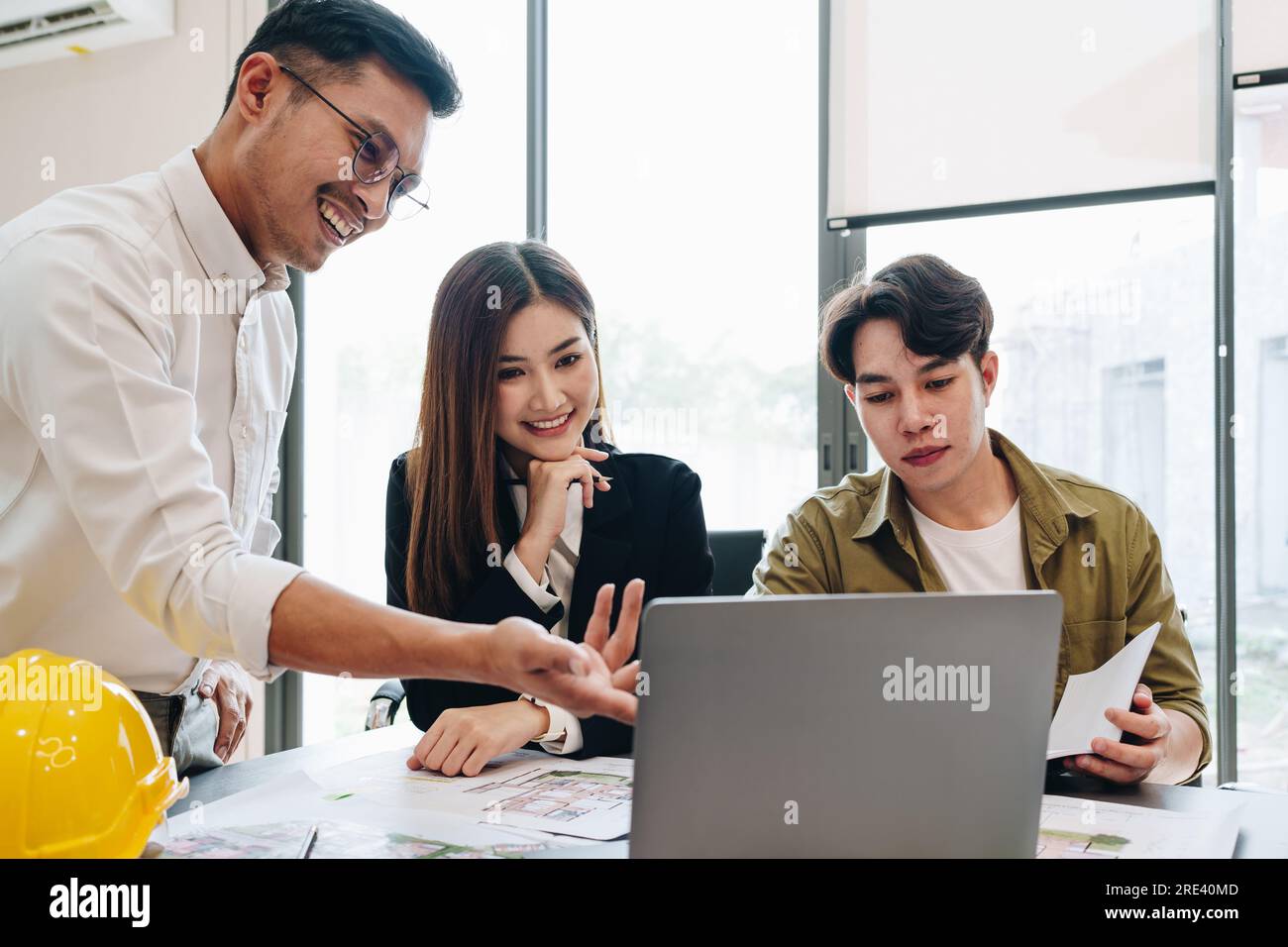 multi ethnic engineer brainstorming and measuring for cost estimating ...