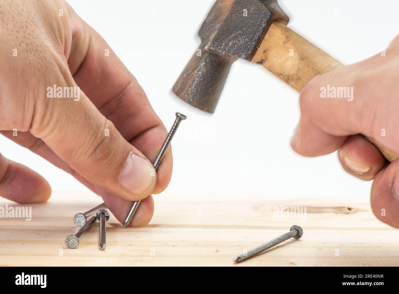 Movement of hands hitting a nail by hammer isolated on white background ...