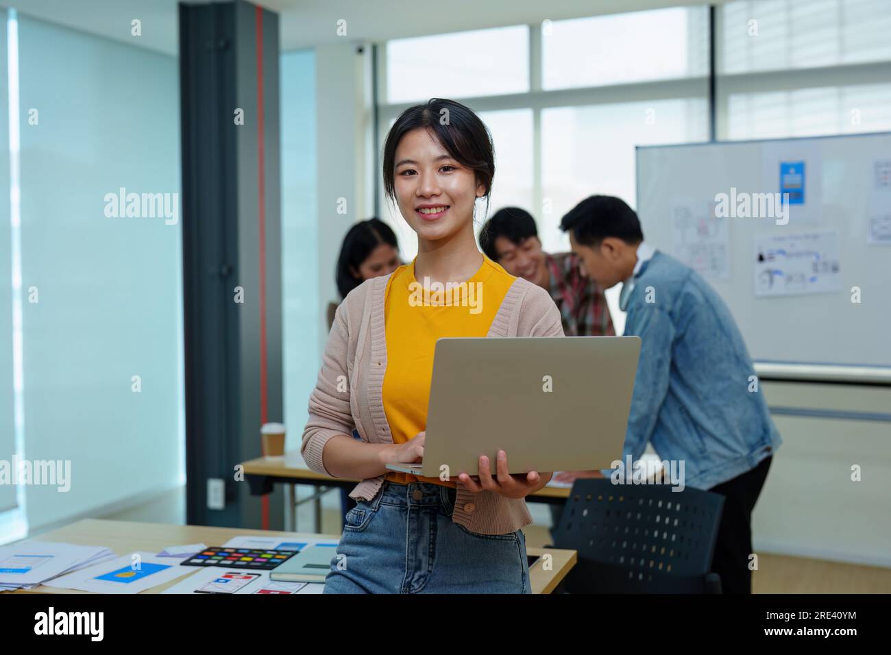 Group of asian creative team programing designers participate in all phases of the UX UI design ...