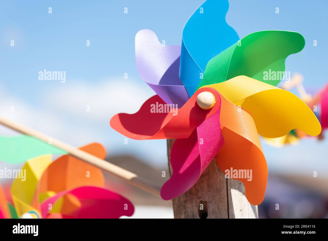 Colorful toy pinwheels with blue sky background Stock Photo - Alamy