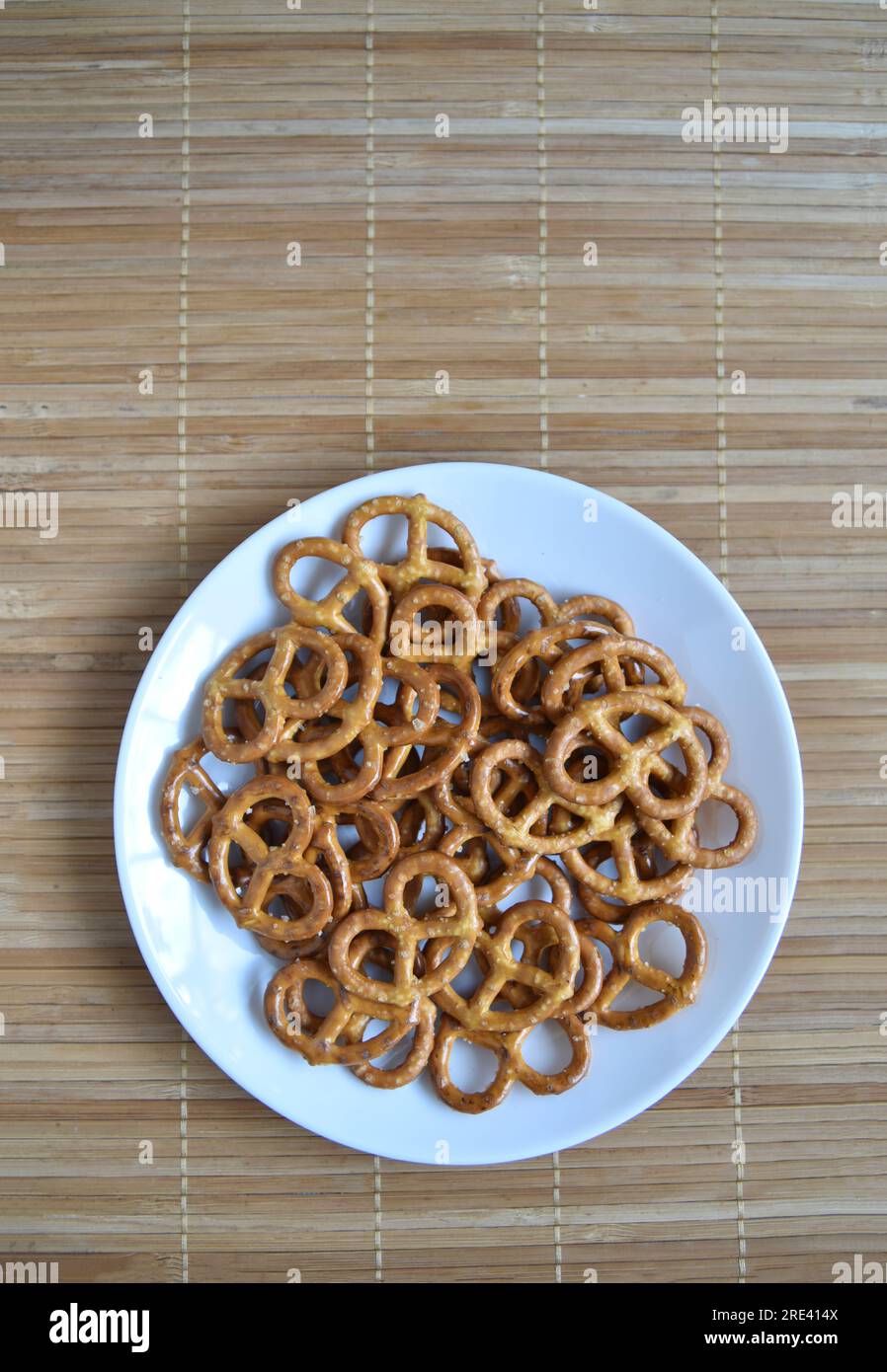 Salty delicious pretzel on a white tea plate. Healthy meal Stock Photo ...