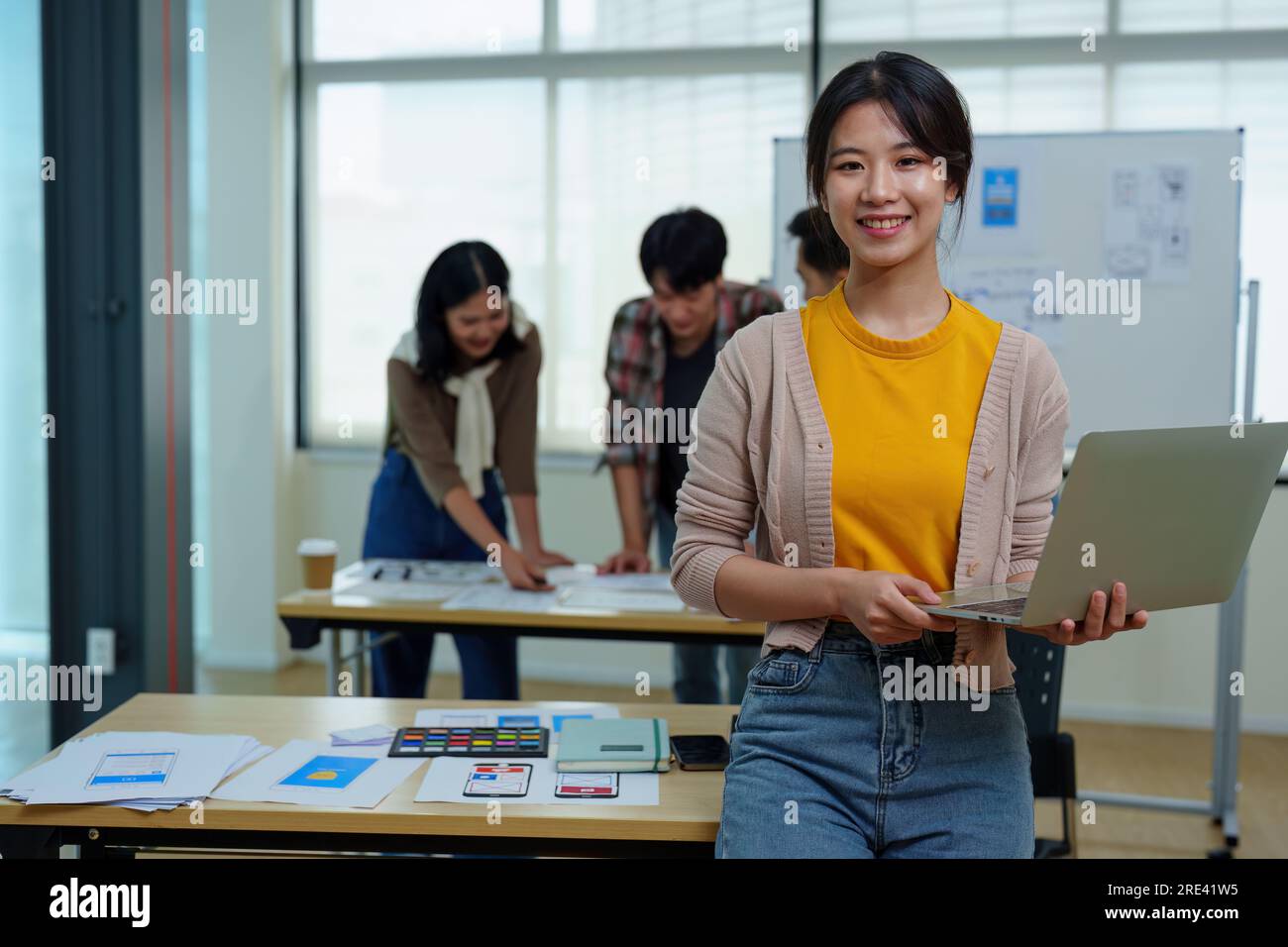 Group of asian creative team programing designers participate in all phases of the UX UI design ...