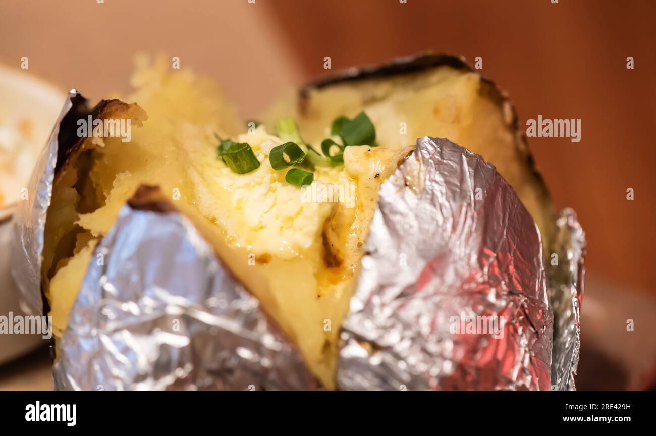 Potato baked slice cover by foil Stock Photo - Alamy