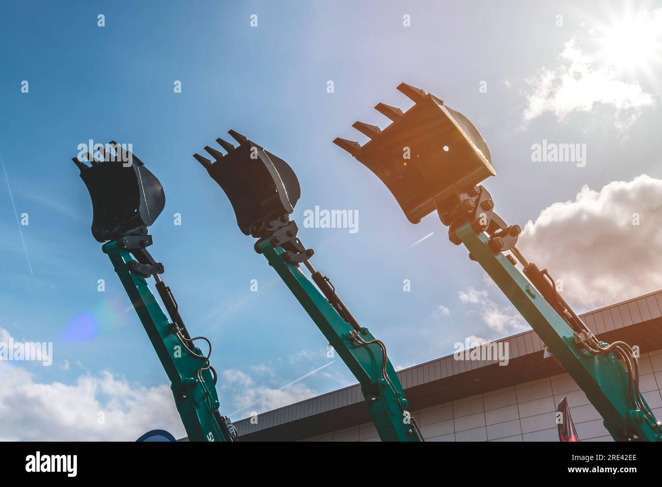 Excavator buckets close-up on ble sky. Digging dirt and mining Stock ...