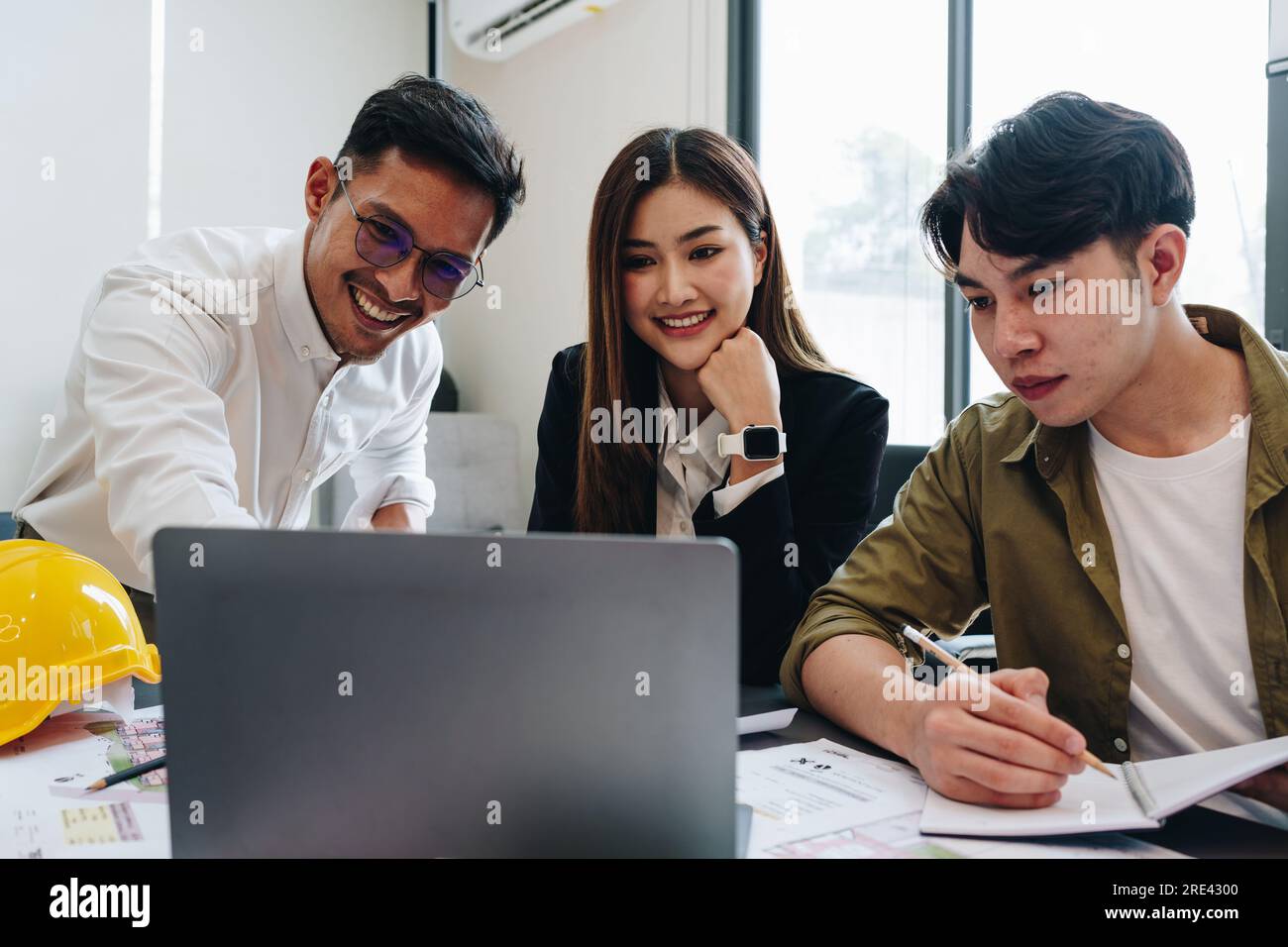 multi ethnic engineer brainstorming and measuring for cost estimating ...