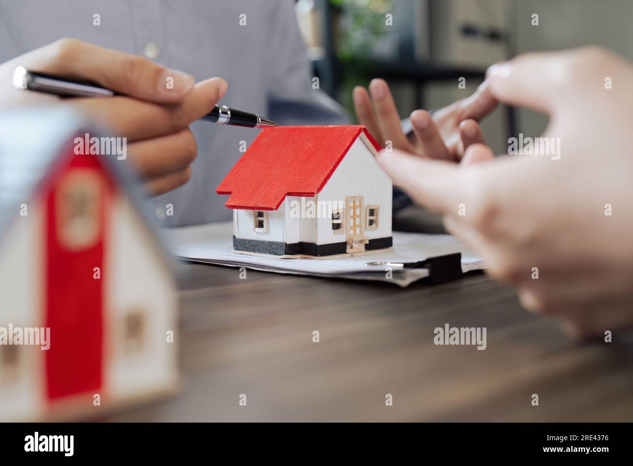 Real Estate Agent and client talking about Property insurance and ...