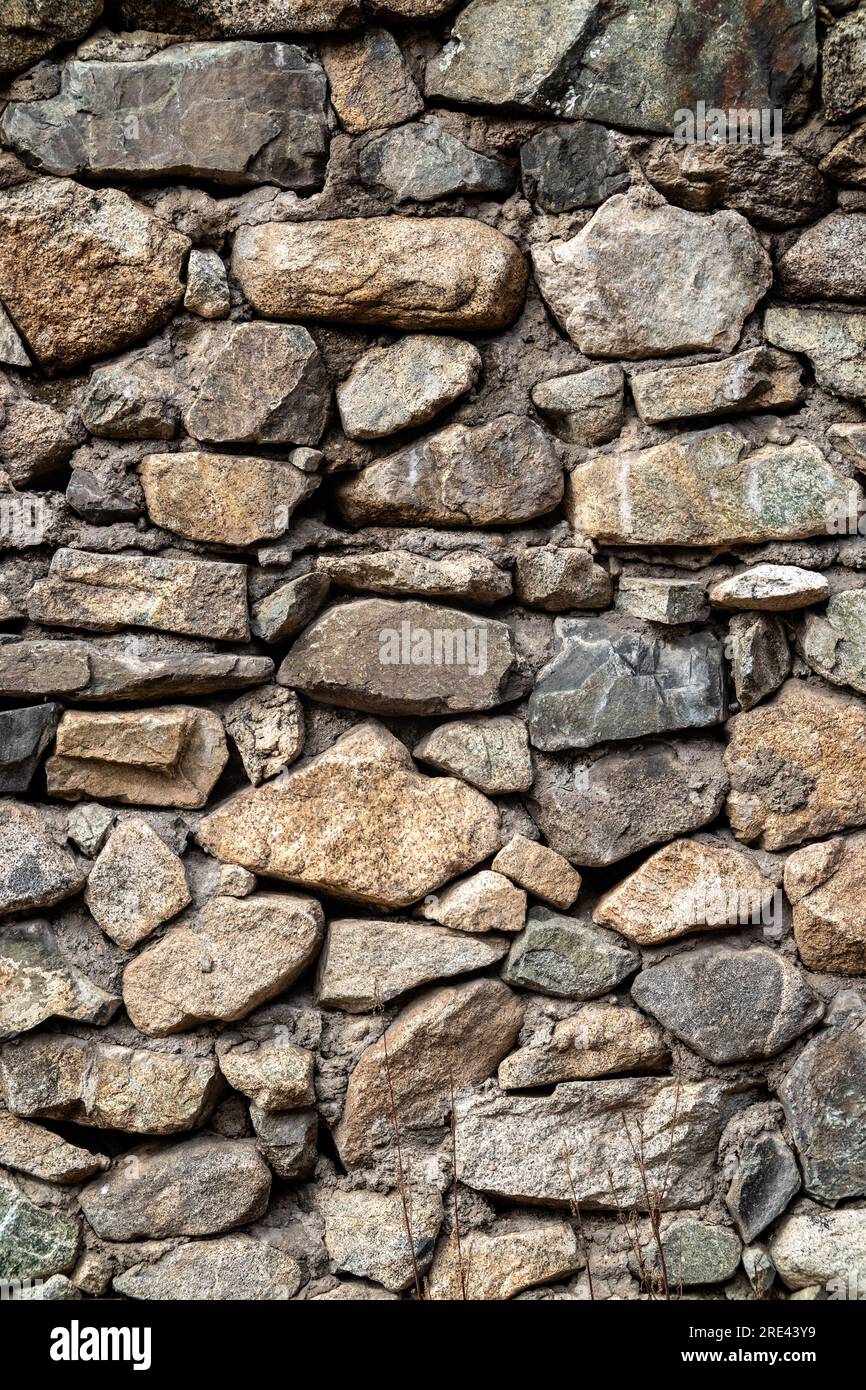 Vertical old background of natural stones bonded with cement mortar ...