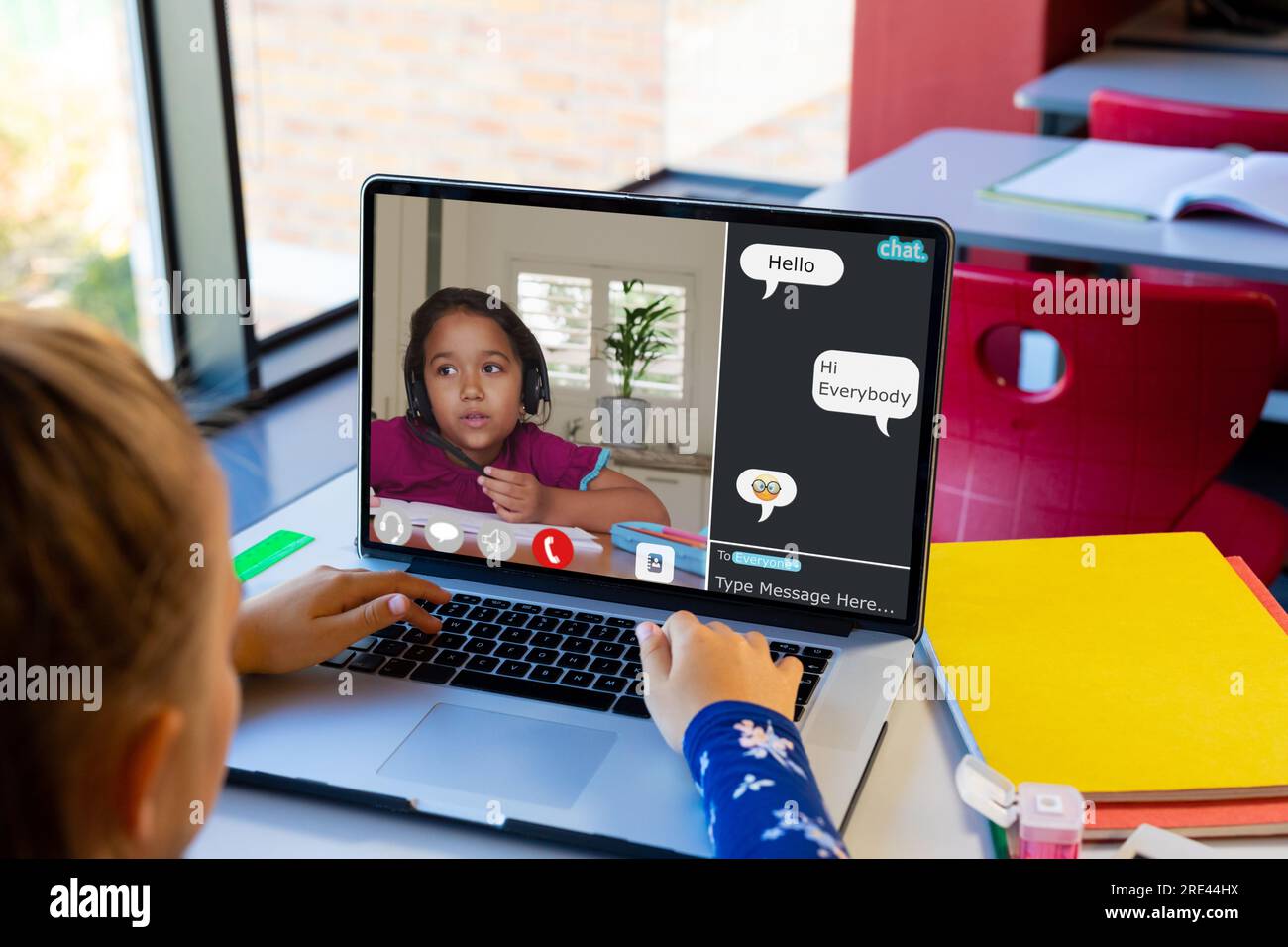 Caucasian girl typing on laptop keyboard and looking at friend during ...