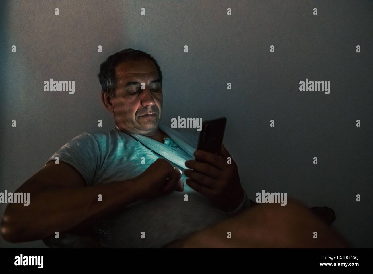 using mobile apps technology on cell phone late at night Stock Photo ...