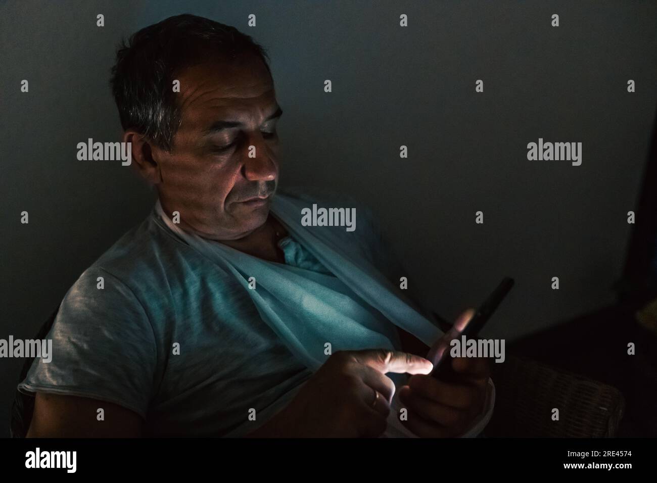 using mobile apps technology on cell phone late at night Stock Photo ...