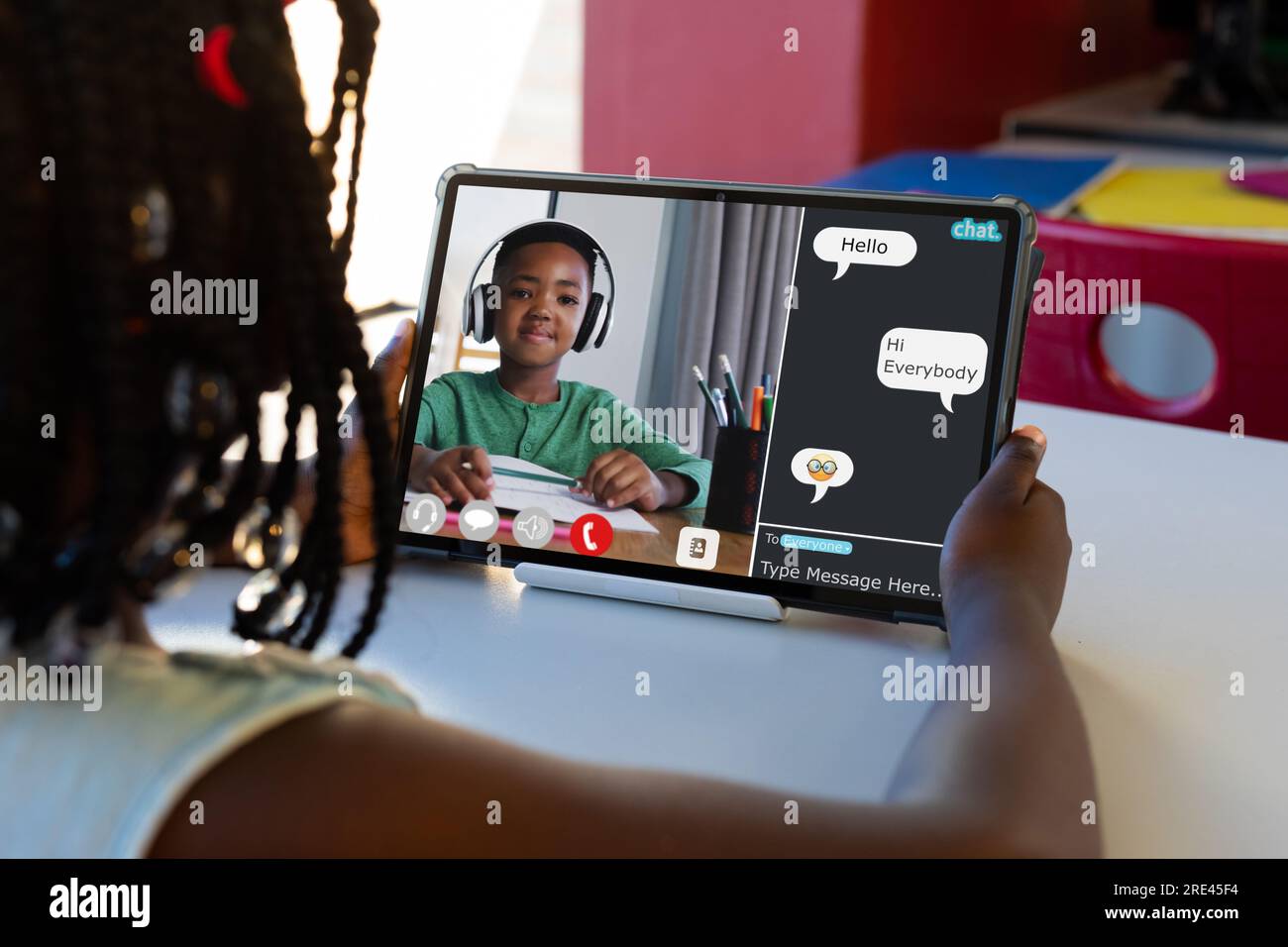 Rear view of african american girl having a video call and texting a ...
