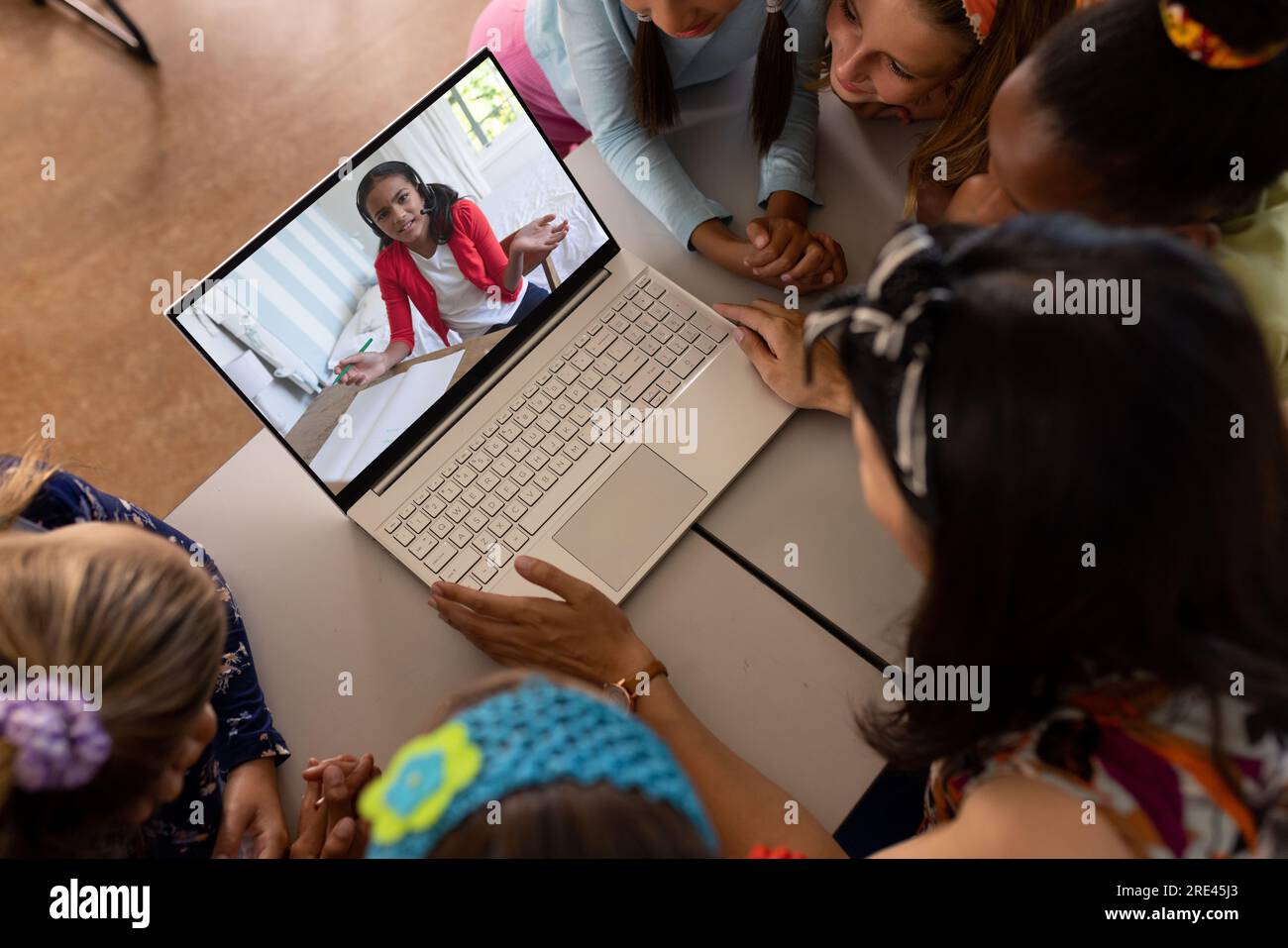 Asian female teacher and diverse students having a video call on laptop ...
