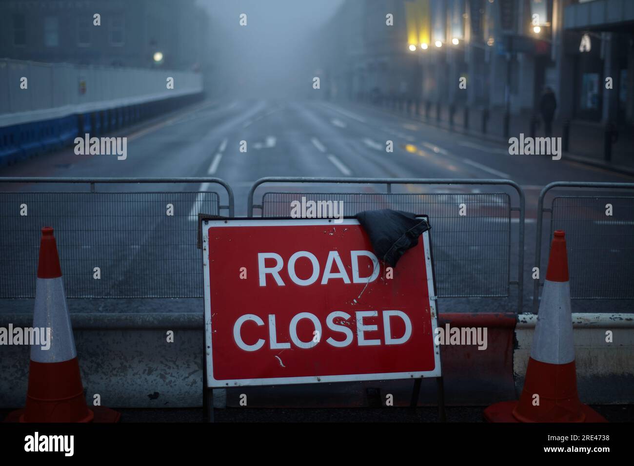 Road closed sign in empty city in the evening Stock Photo - Alamy
