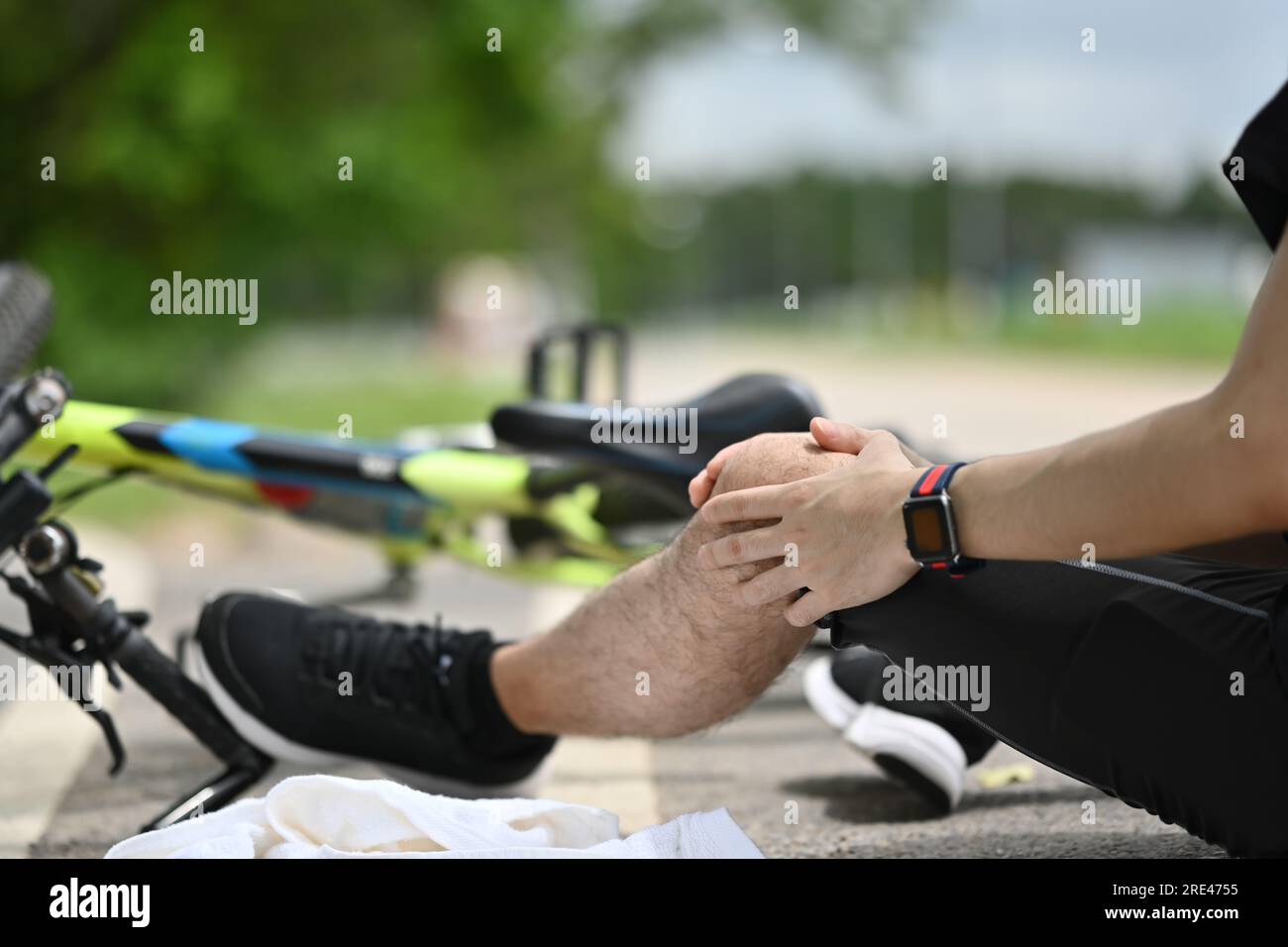 Male cyclist having an accident, falling down from bicycle and injured ...