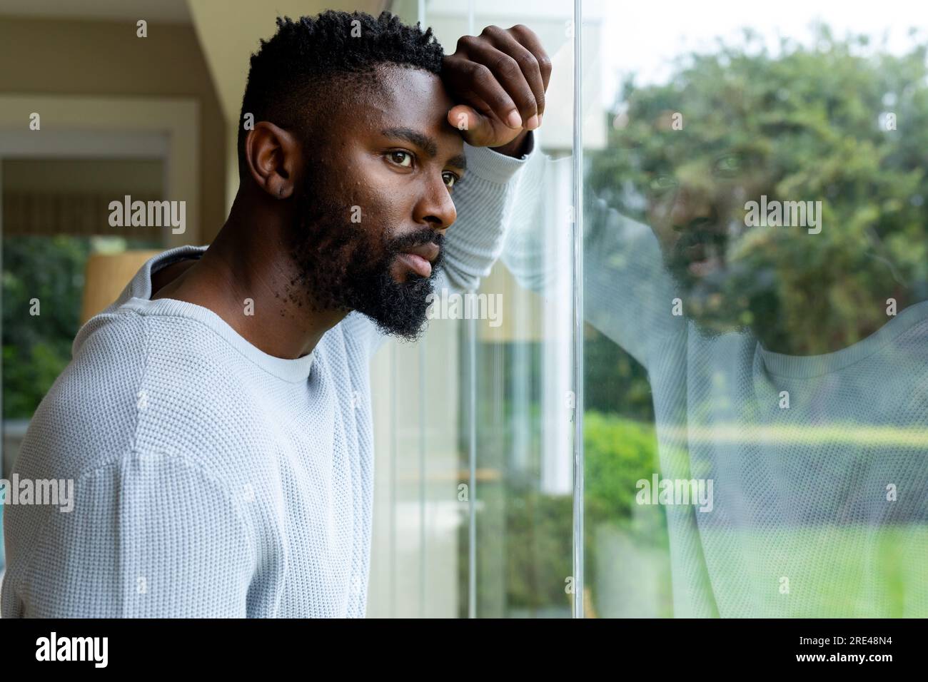Man looking window home hi-res stock photography and images - Alamy