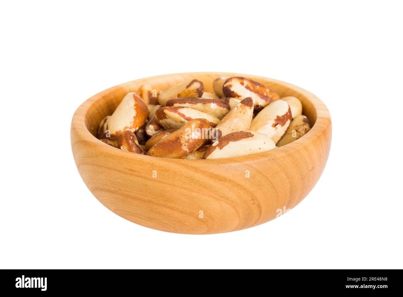 Roasted Brazil nut in bowl isolated on white background. Brazil nut is ...