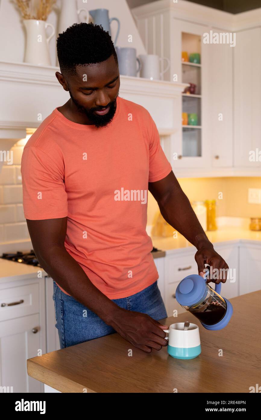 Happy african american man making coffee in white kitchen Stock Photo ...