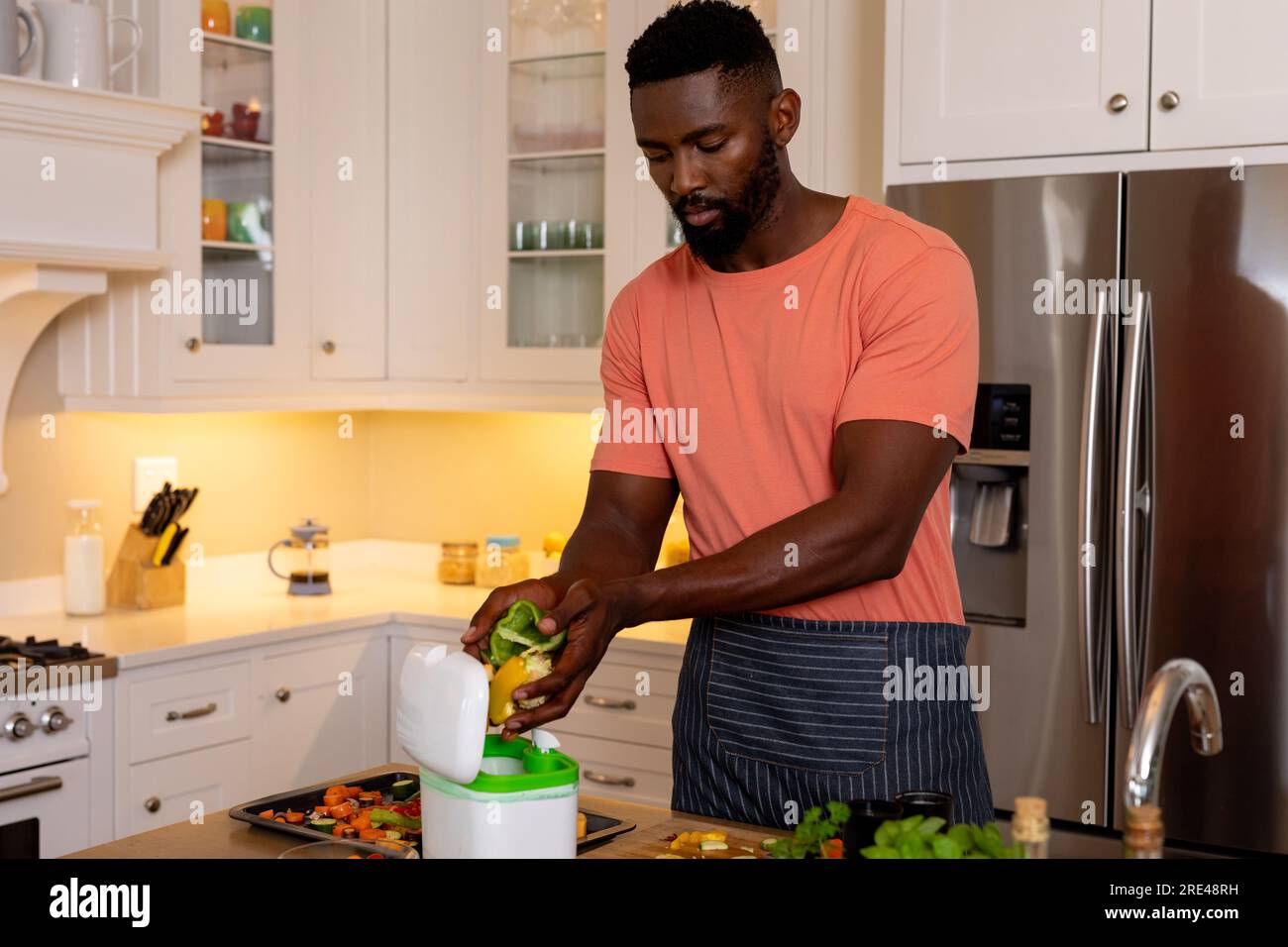 African american man composting vegetable waste in kitchen Stock Photo ...