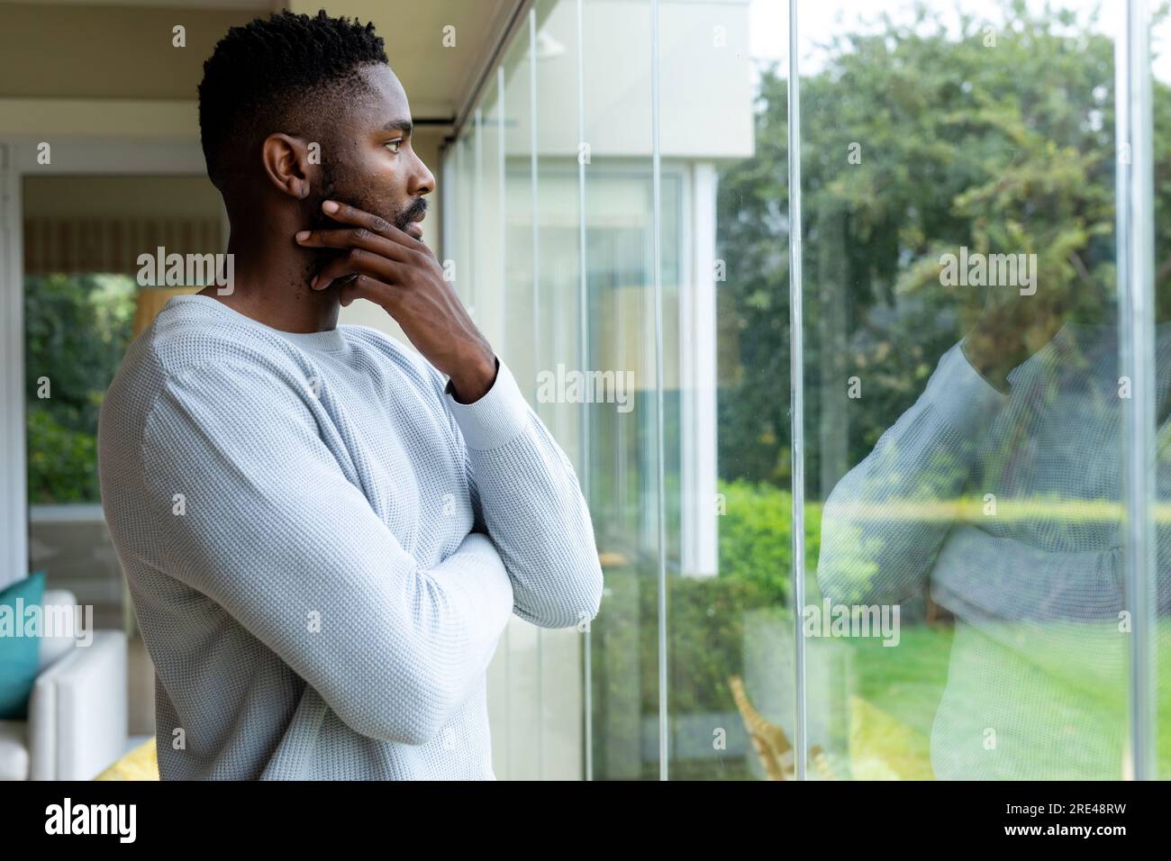 Man looking window home hi-res stock photography and images - Alamy