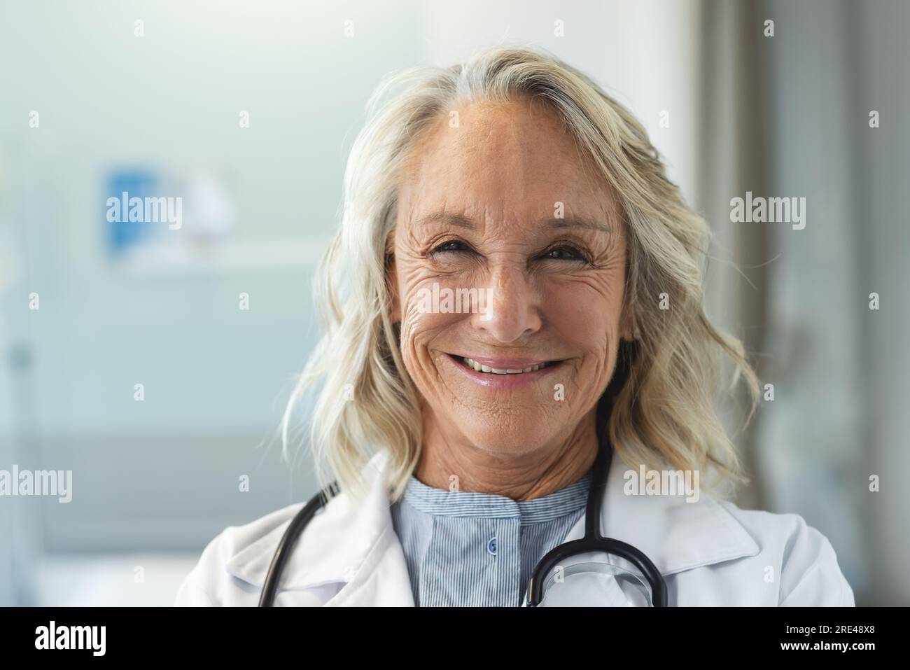 Portrait of happy senior caucasian female doctor wearing lab coat and ...