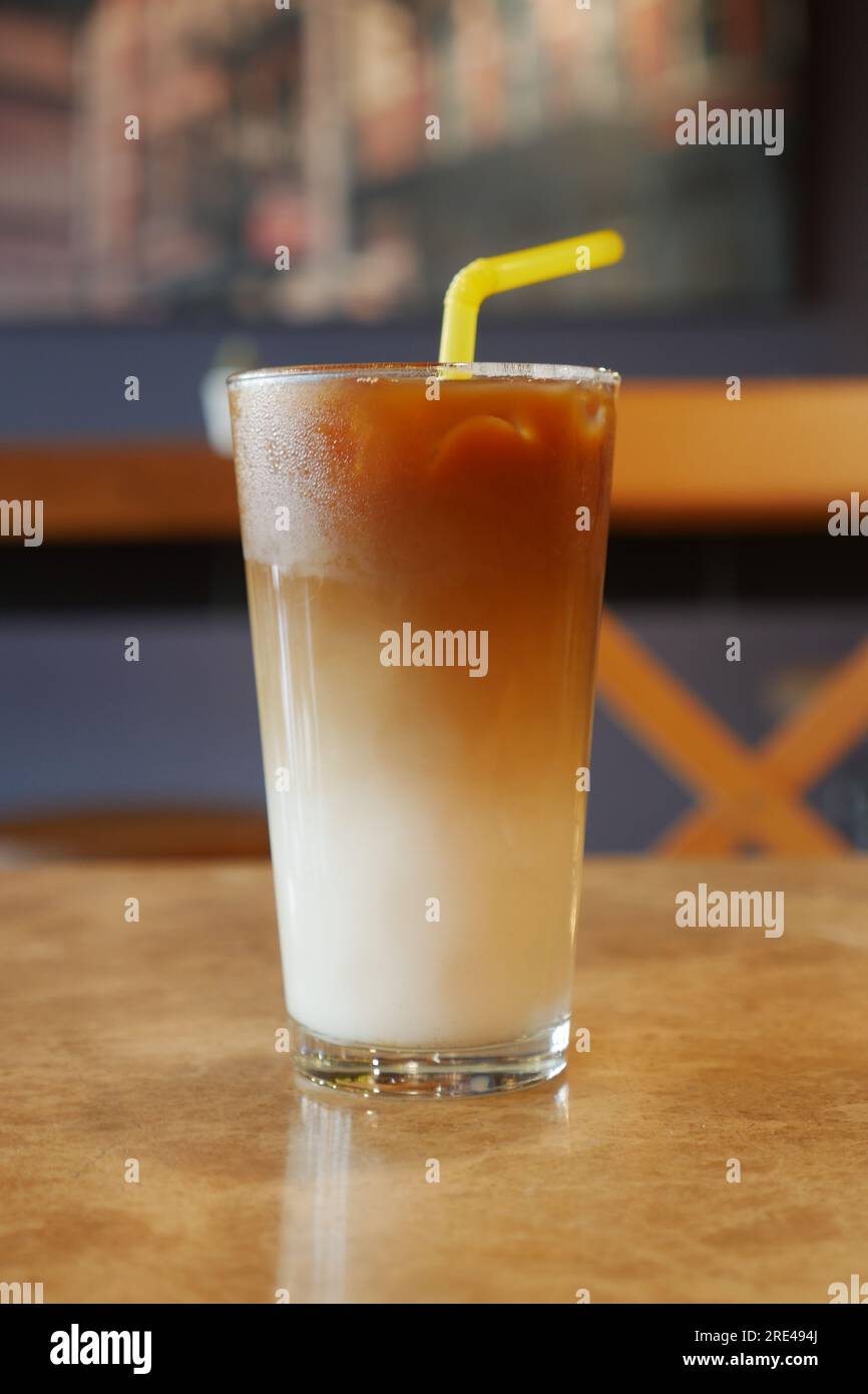 ice coffee in a container on cafe table Stock Photo - Alamy