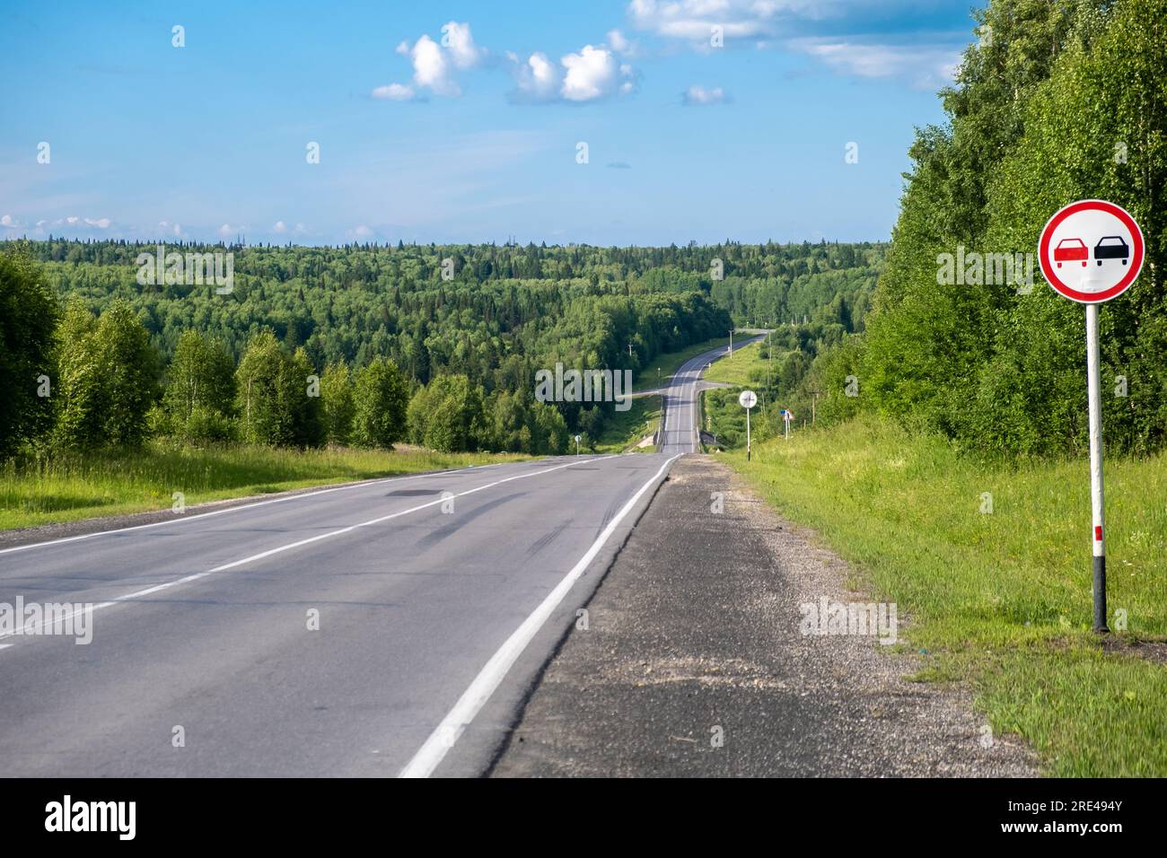 A road sign Overtaking is prohibited on a suburban highway through ...